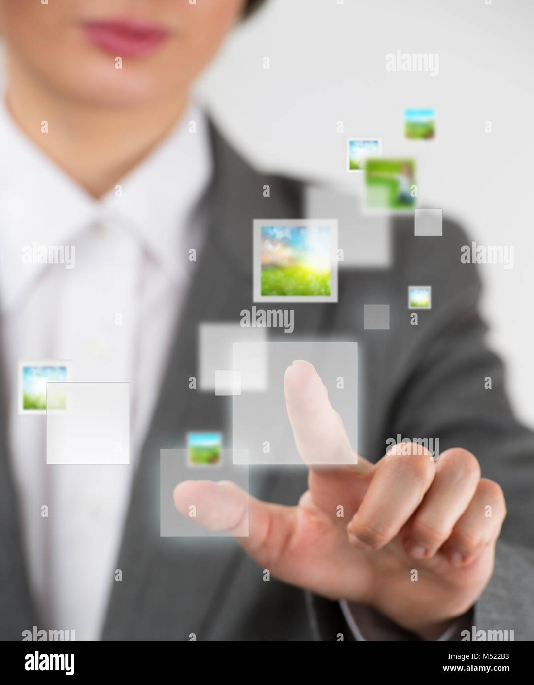 Young business woman pushing a button on a virtual touch screen with ...