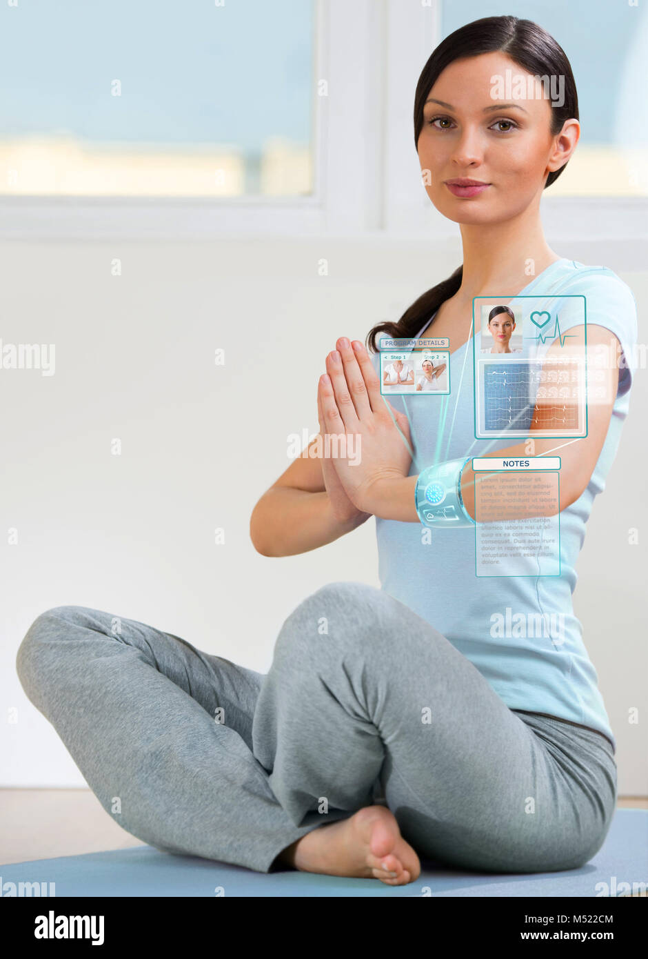 Woman doing exercise wearing smart wearable device with futuristic ...