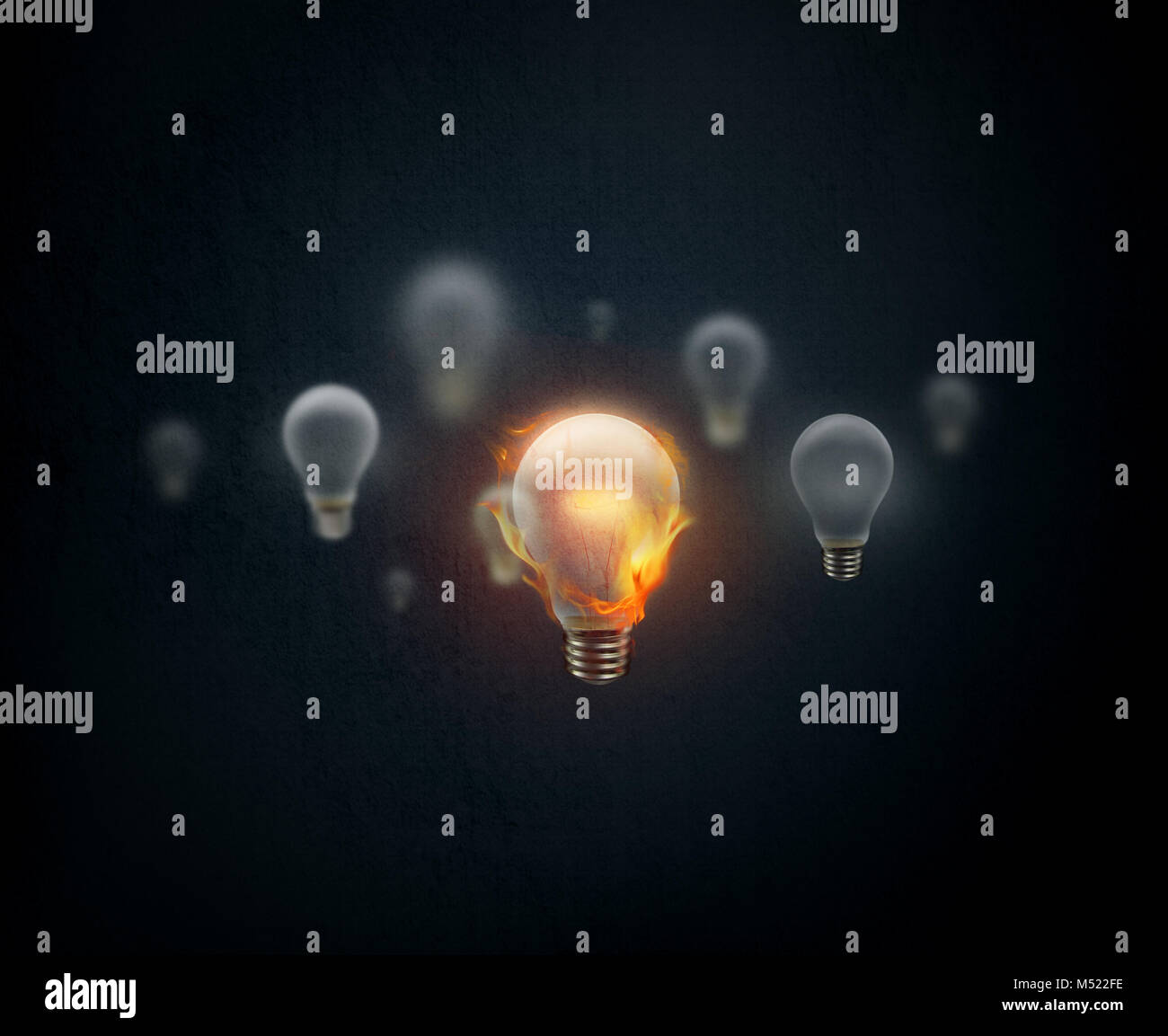 Idea concept. Light bulb burning in flame on dark blue background Stock ...