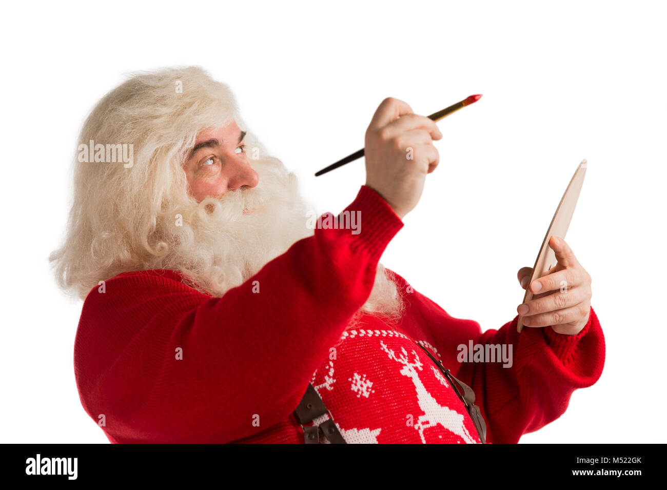 Portrait of Santa Claus painting with brush and palette isolated on ...