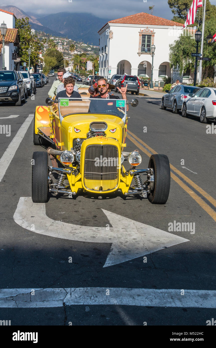 A yellow convertible hot rod limousine drives paying tourists around ...