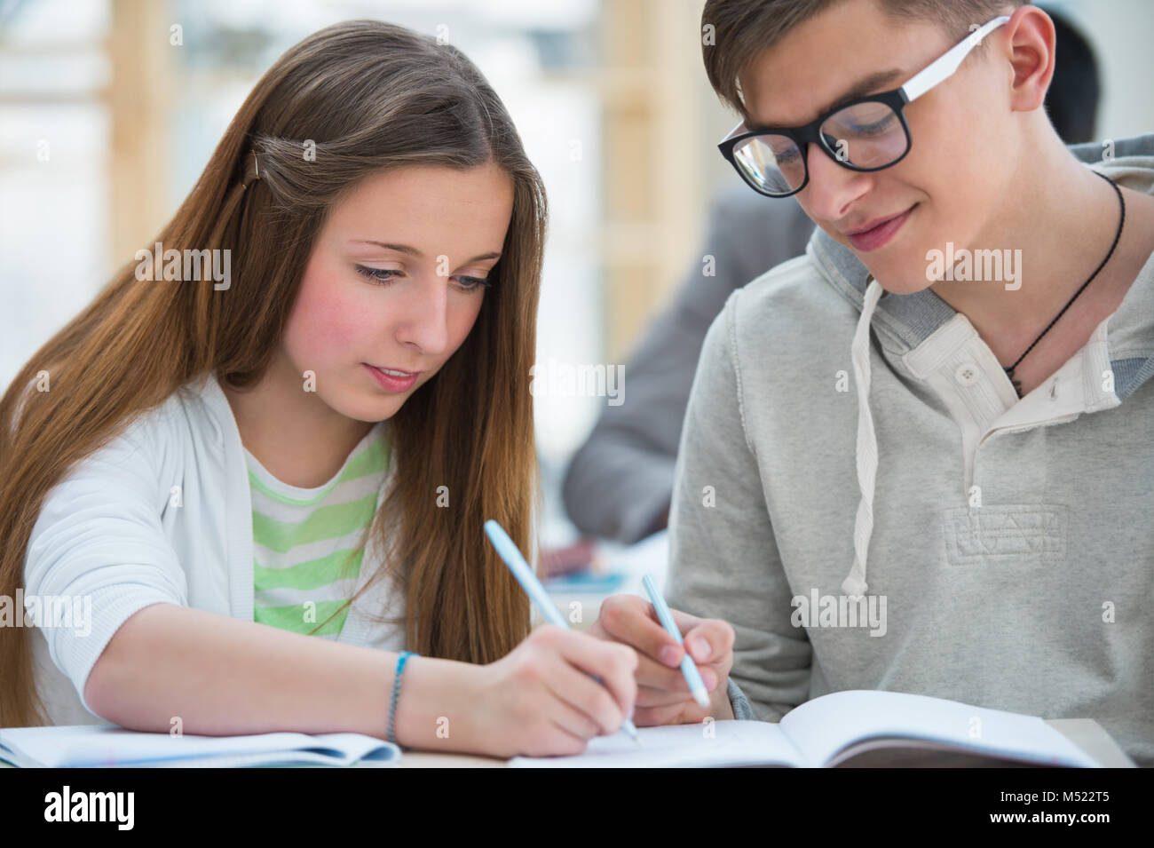 High School students. Girl and boy study together and help each other ...