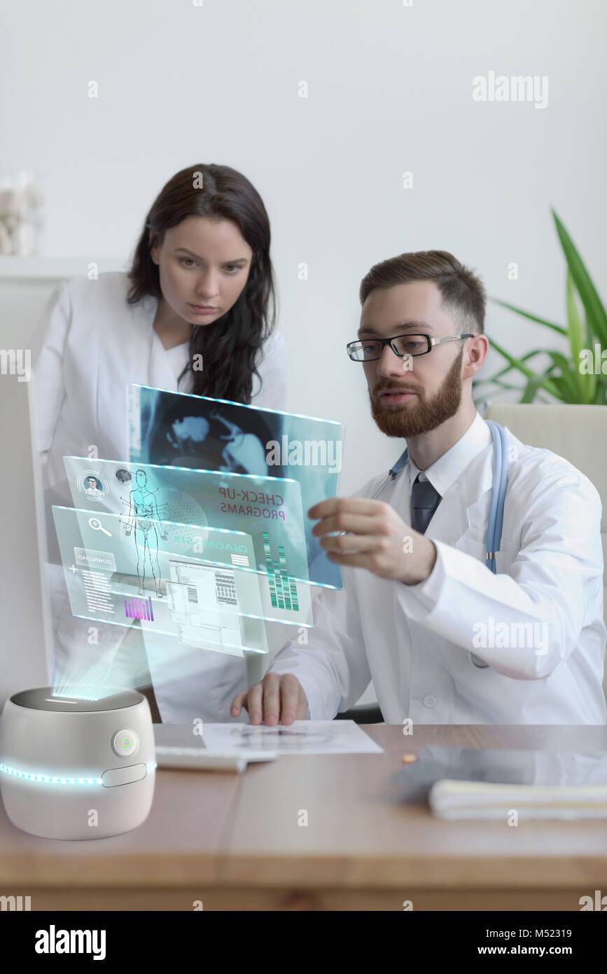 Doctors discussing intestines xray at medical office Stock Photo - Alamy