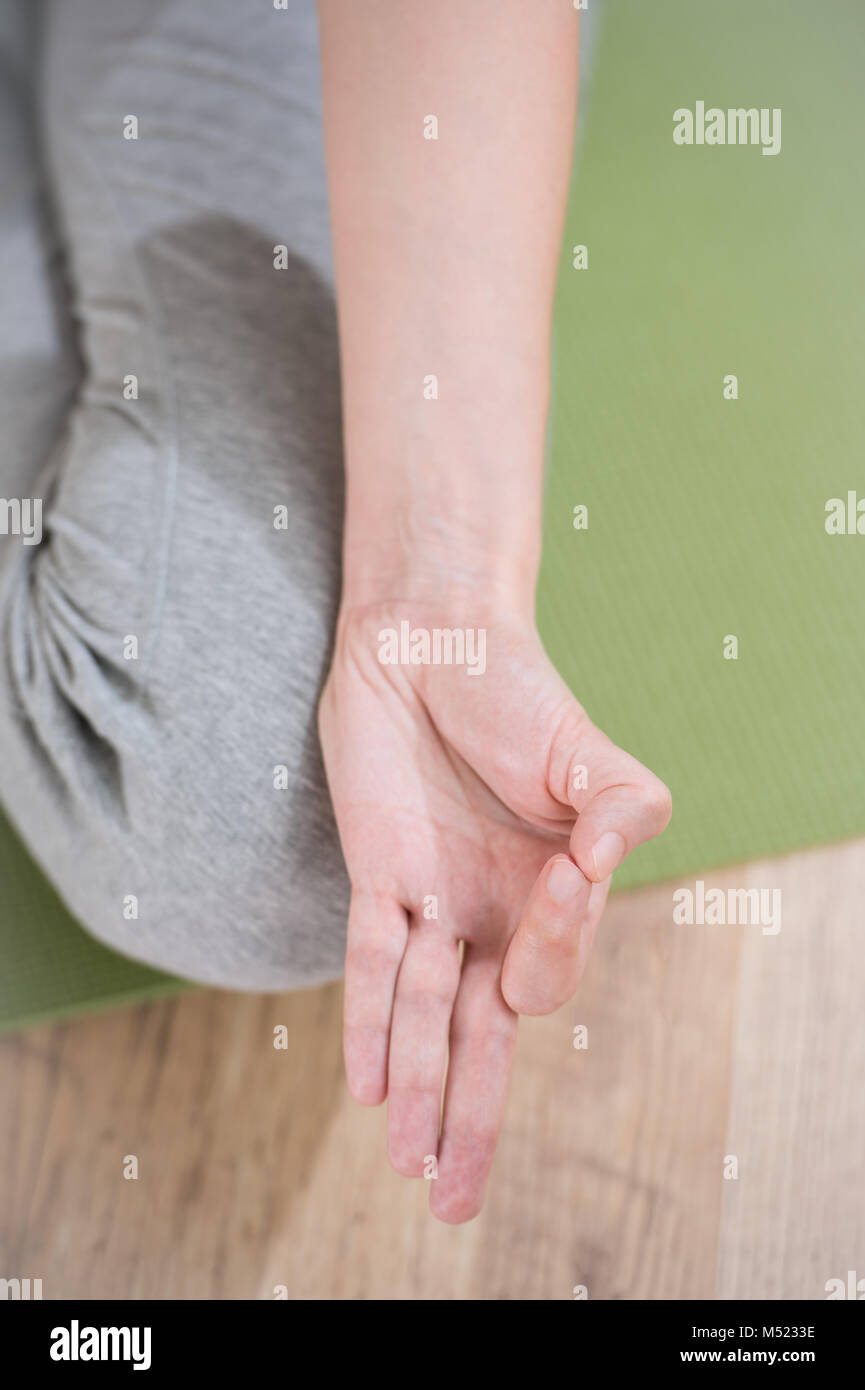 Closeup part of female body meditating. Focus on fingers Stock Photo ...
