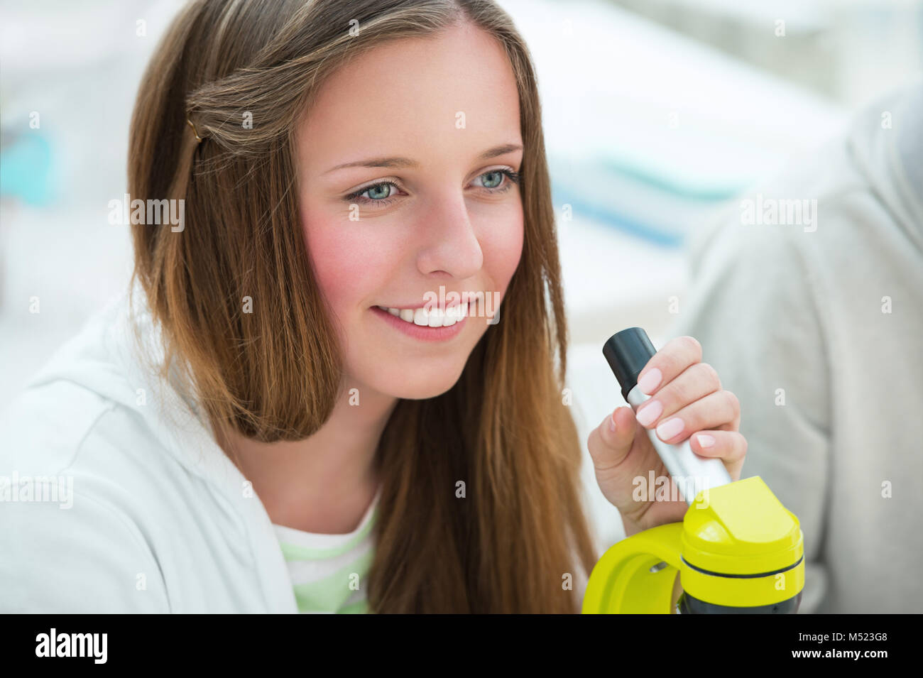 High School students. Beautiful girl working at biology classroom ...