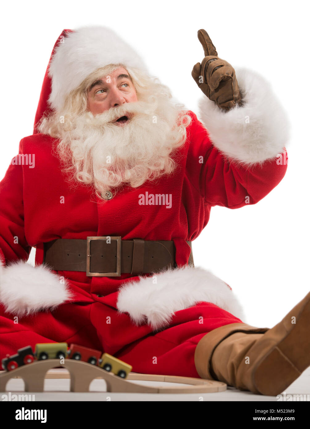 Hilarious and funny Santa Claus sitting and playing with toys on a ...