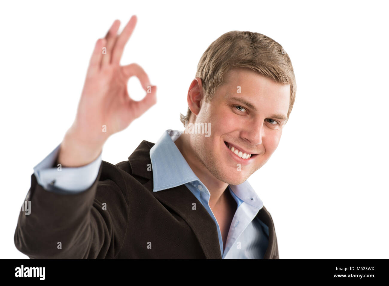 Portrait of a business man giving a good job sign isolated against ...