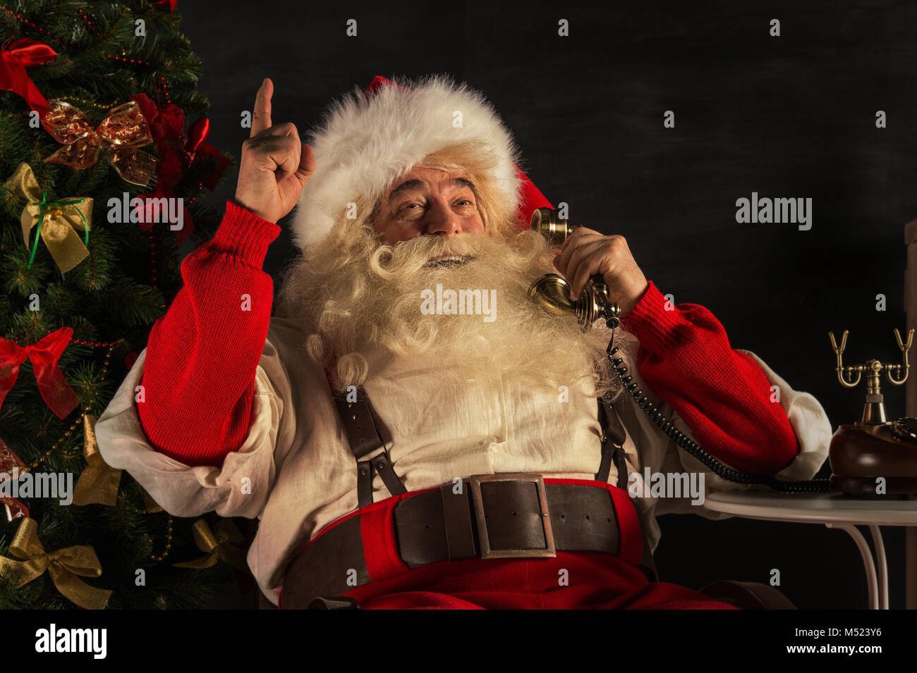 Portrait of emotional Santa Claus calling phone at home Stock Photo - Alamy