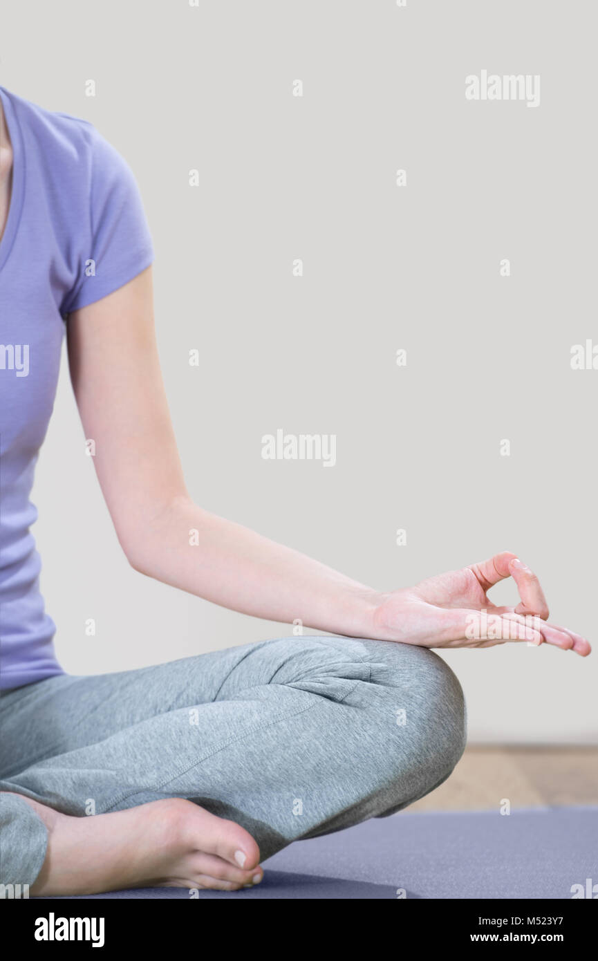 Closeup part of female body meditating. Focus on fingers Stock Photo ...