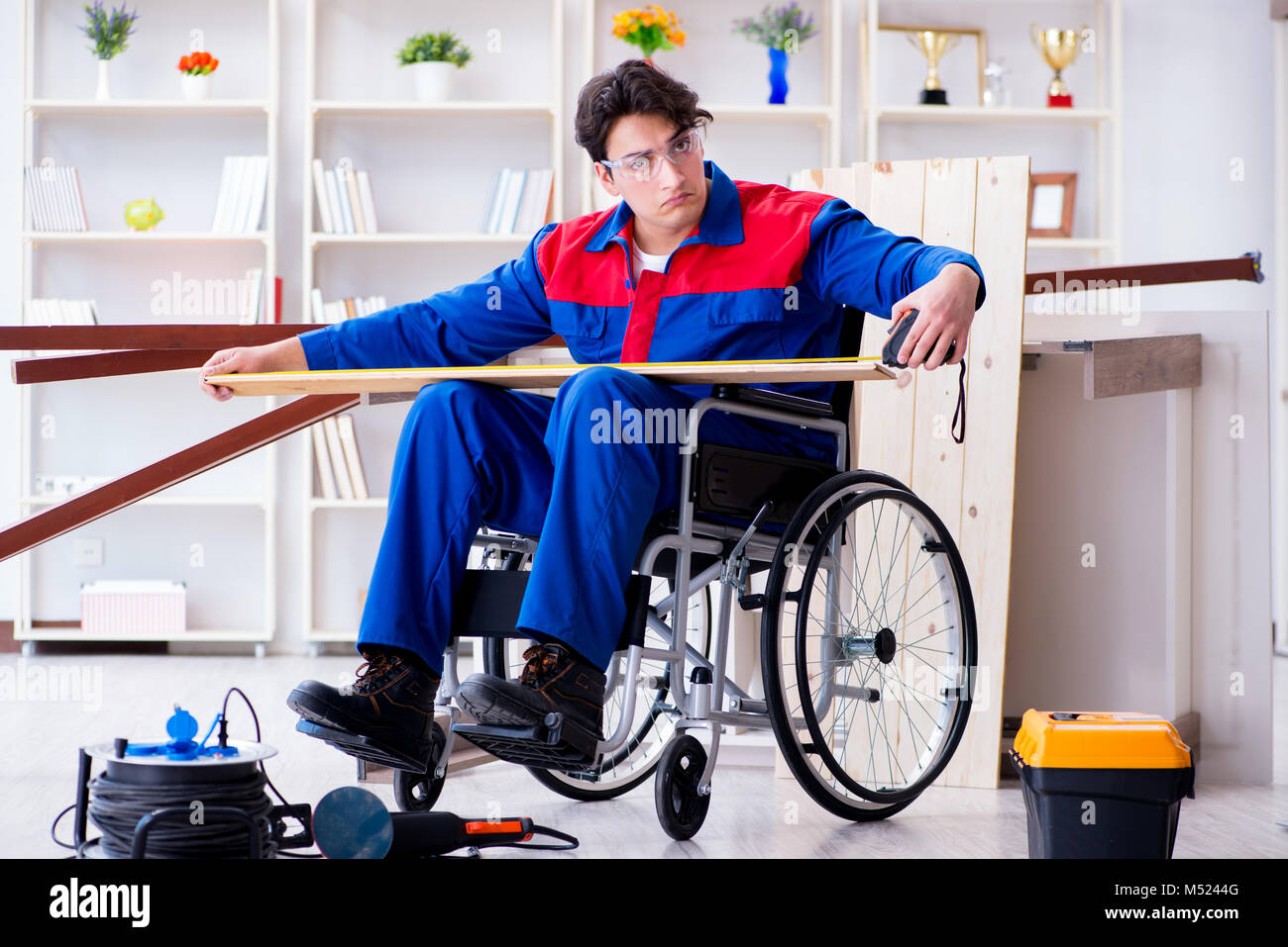 The disabled carpenter taking measurement in workshop Stock Photo - Alamy