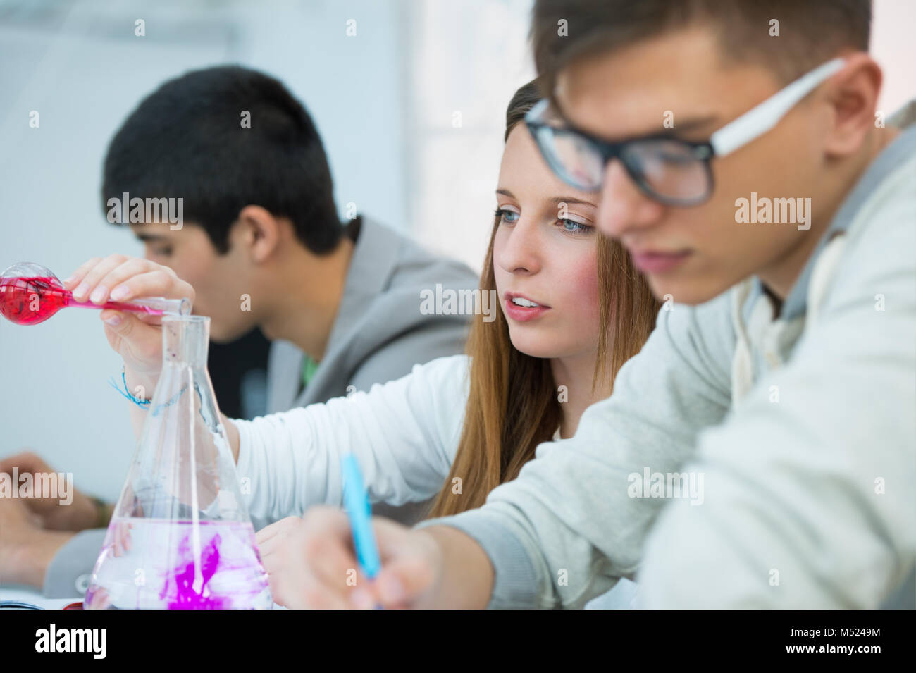 High School students. Group of students working at chemistry class ...