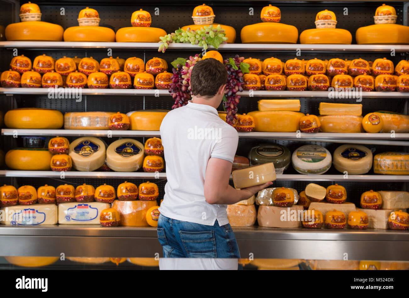 Handsome male owner of a cheese store working Stock Photo - Alamy