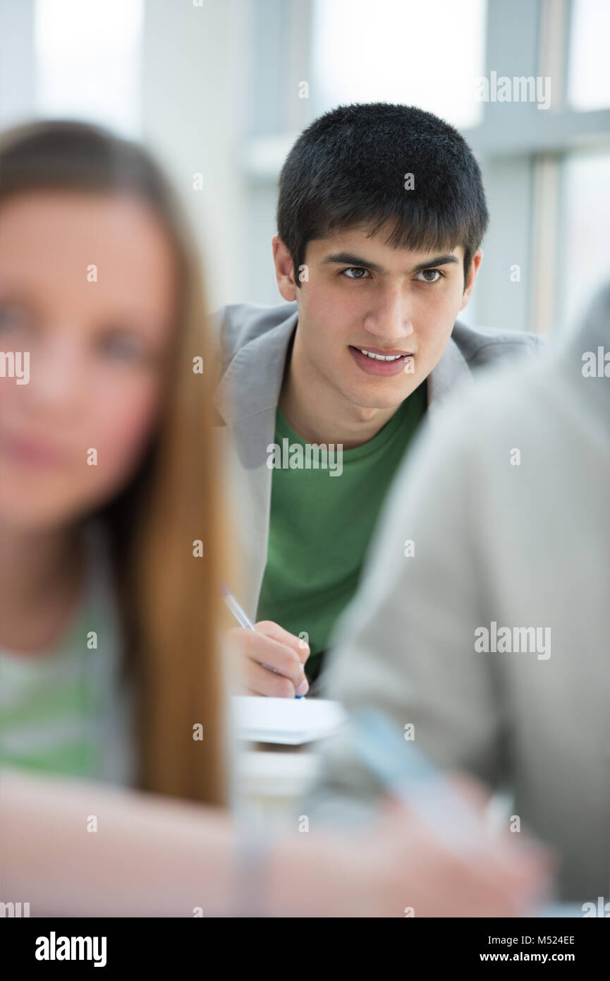 Group of students studying together in classroom Stock Photo - Alamy