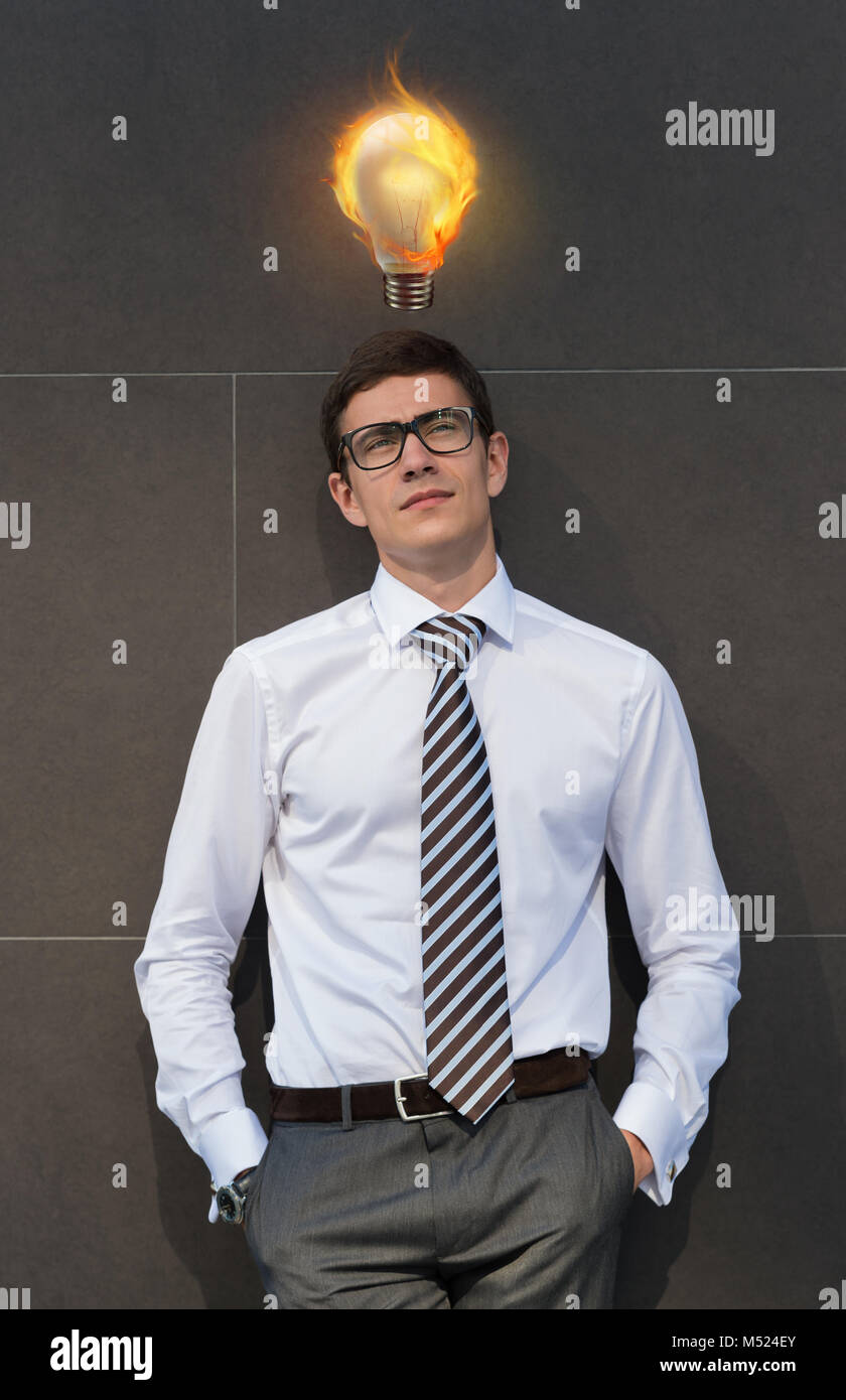 Beautiful business man with idea light bulb above head on gray ...