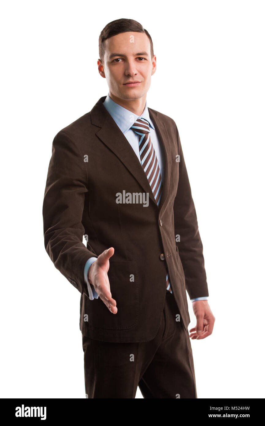 Portrait of a smiling young business man offering a welcoming hand isolated on white background ...