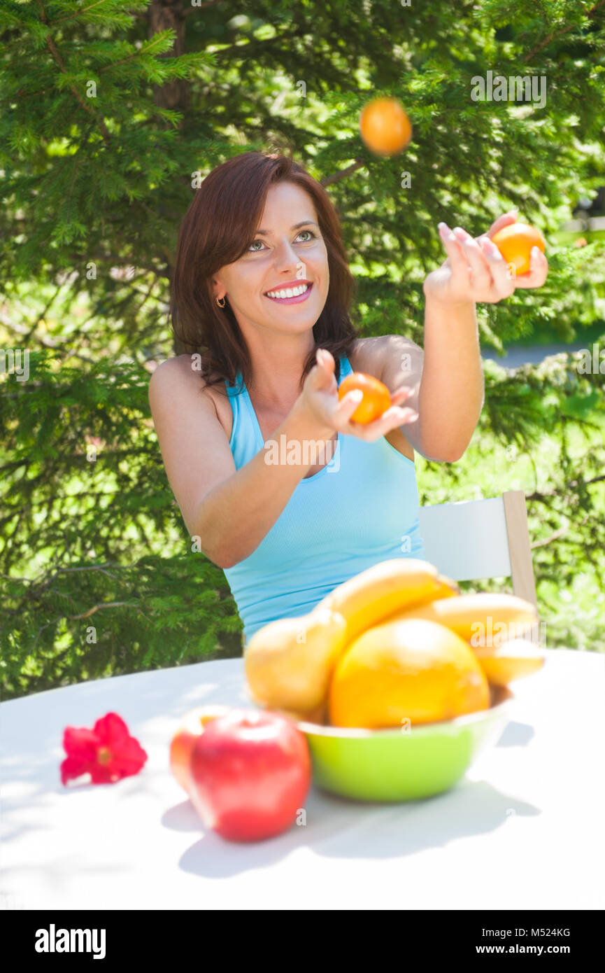 Happy Smiling Young Woman Juggling Oranges at her Garden Stock Photo ...