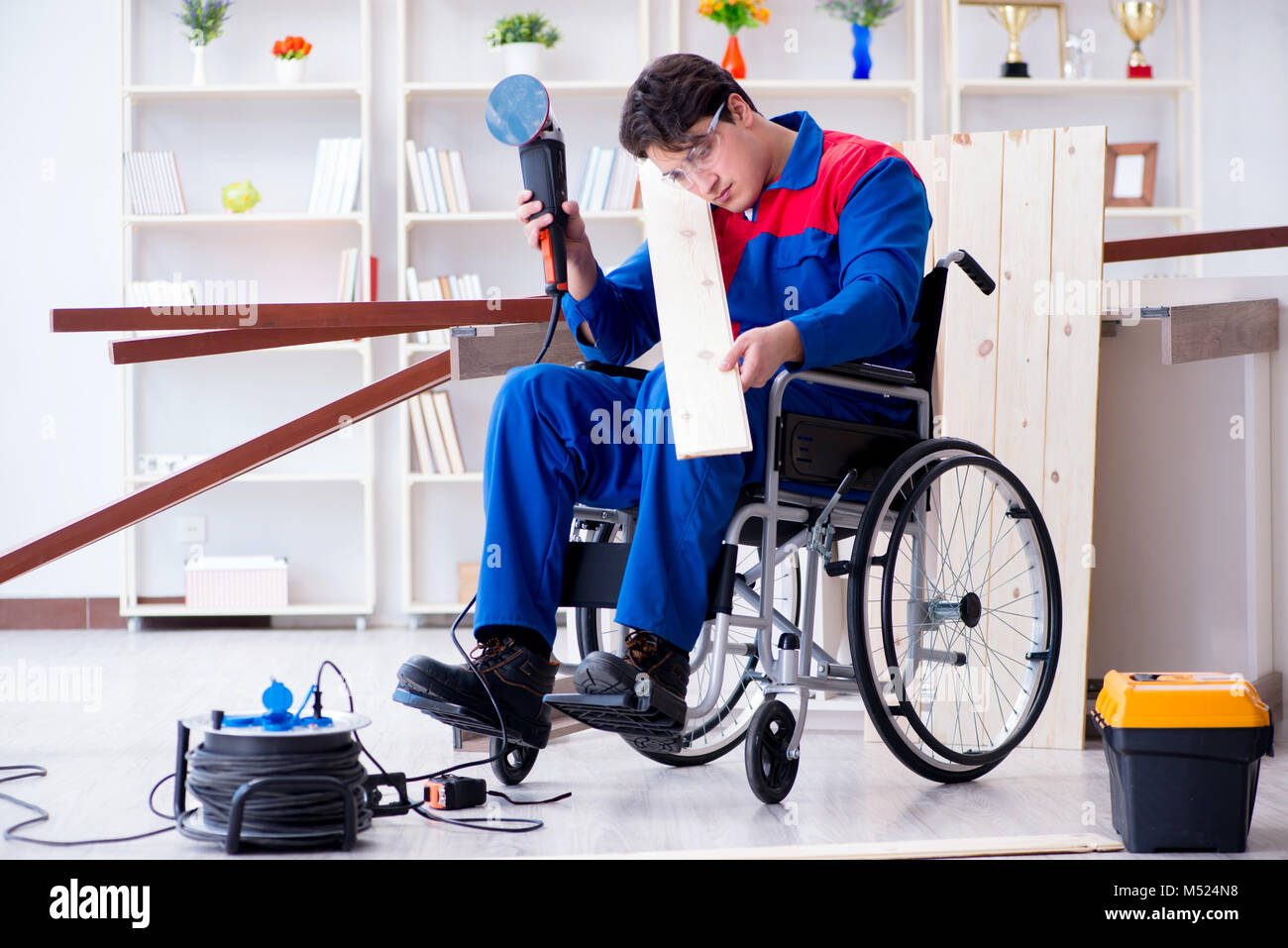 The disabled carpenter working with tools in workshop Stock Photo - Alamy