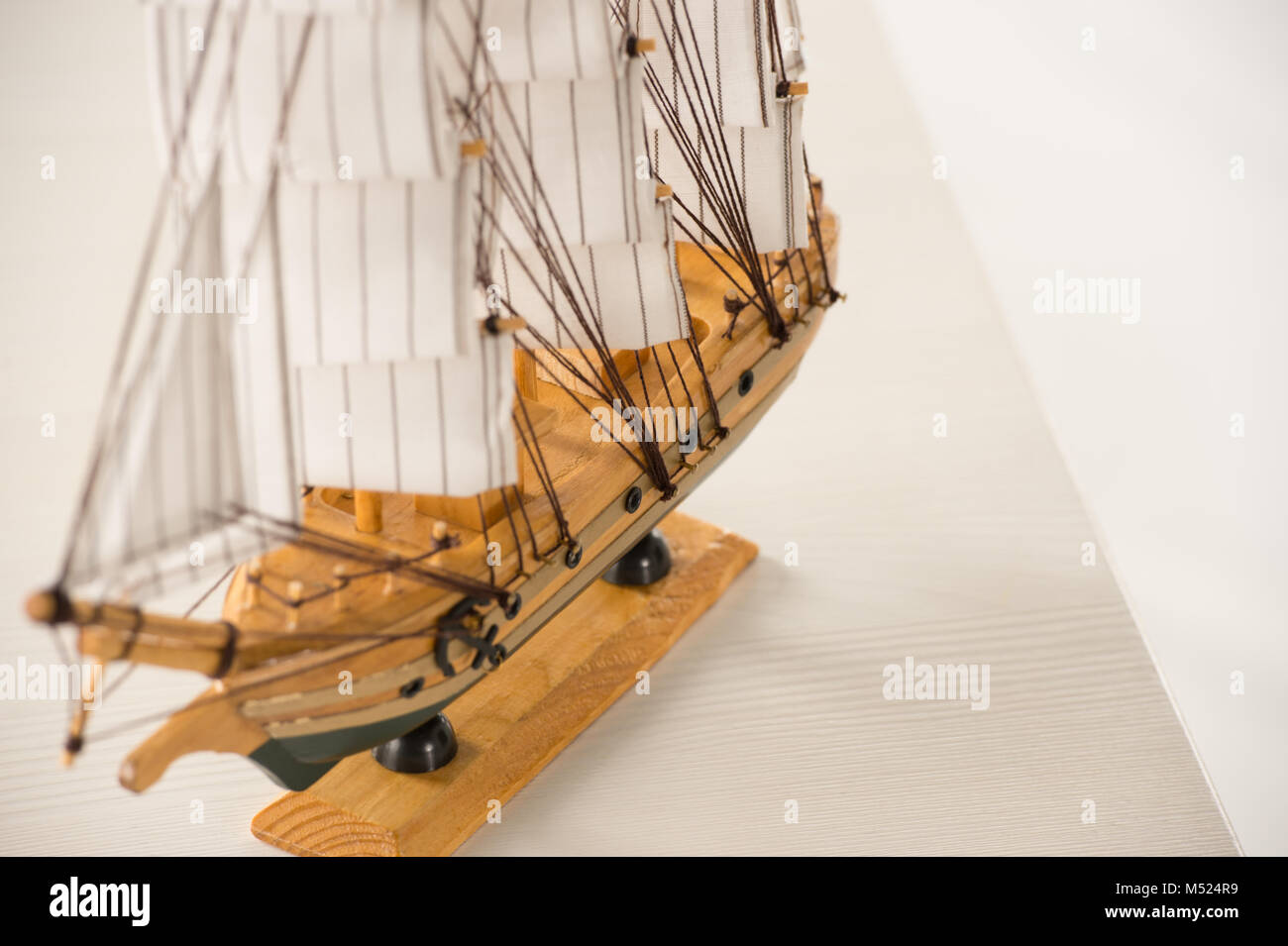 Wooden ship toy model on white table against white background Stock ...