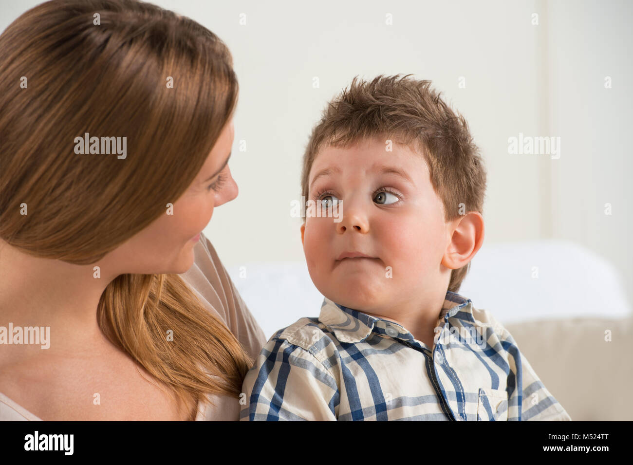 Happy mother talking to her son at home Stock Photo - Alamy
