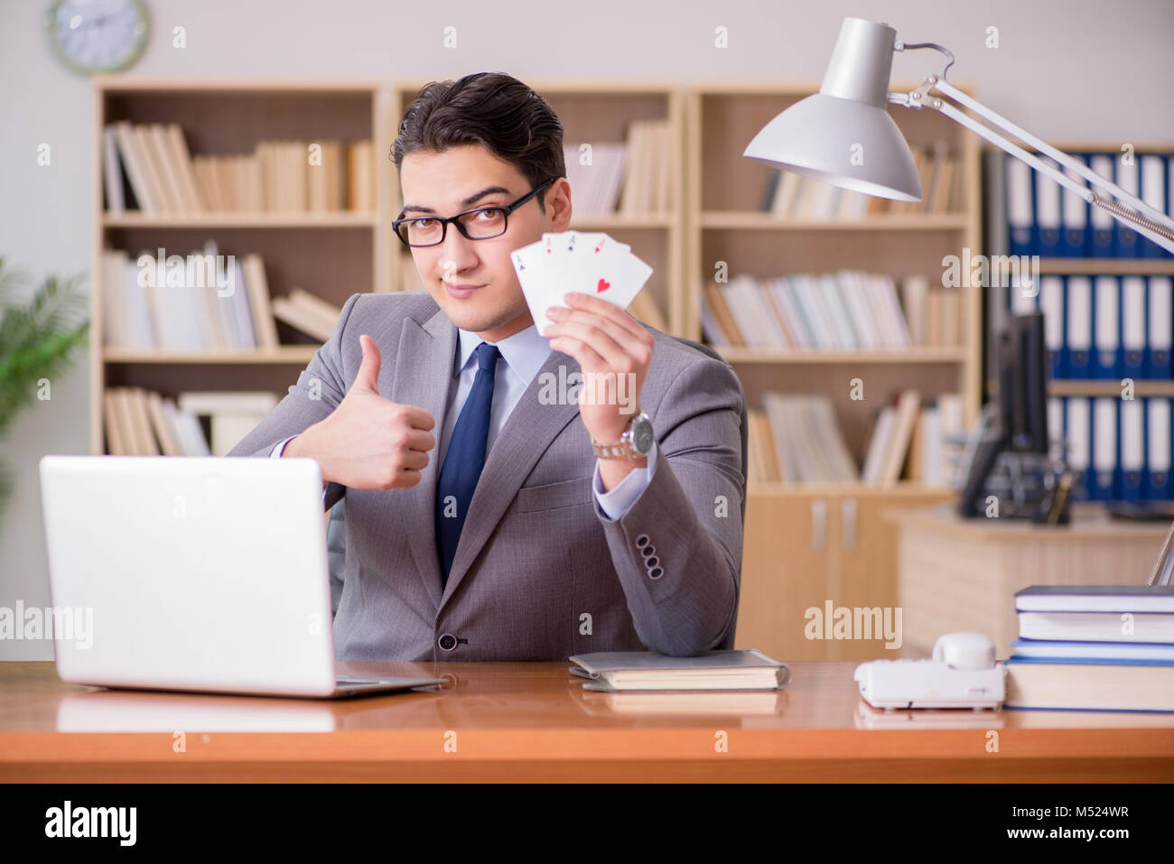 The businessman gambling playing cards at work Stock Photo - Alamy