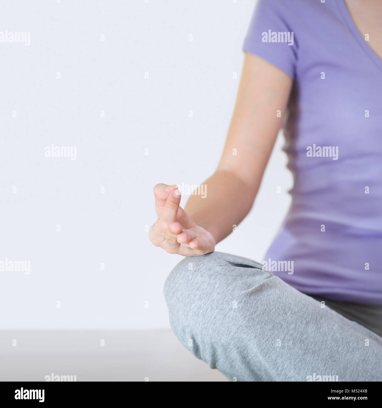 Closeup part of female body meditating. Focus on fingers Stock Photo ...
