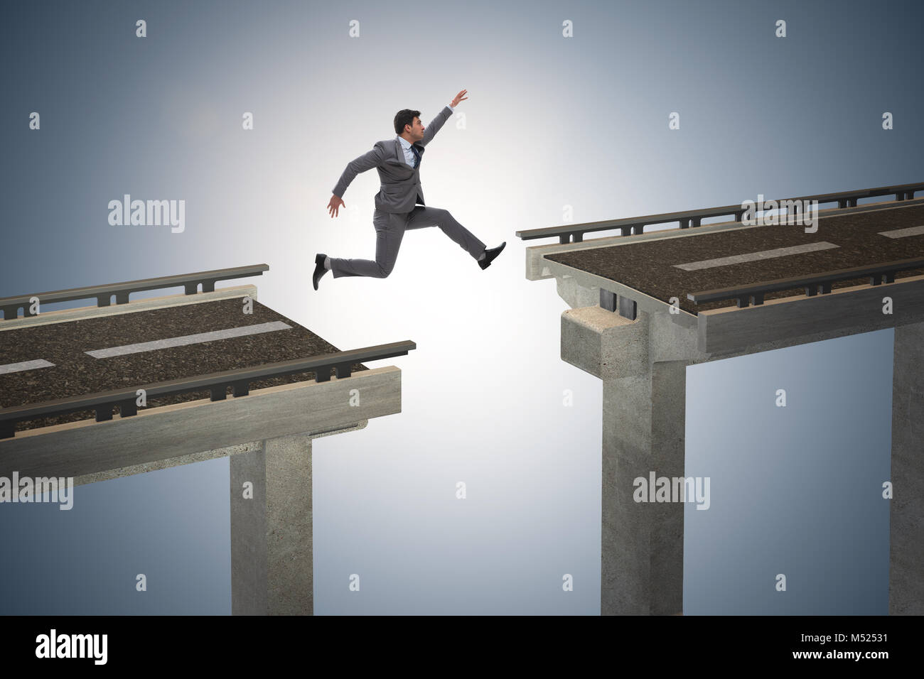 The young businessman jumping over the bridge Stock Photo - Alamy