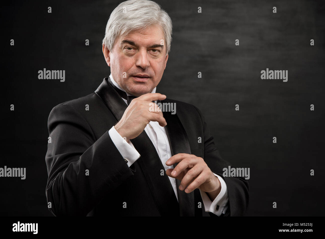 Portrait of professional hypnotist on black background Stock Photo - Alamy
