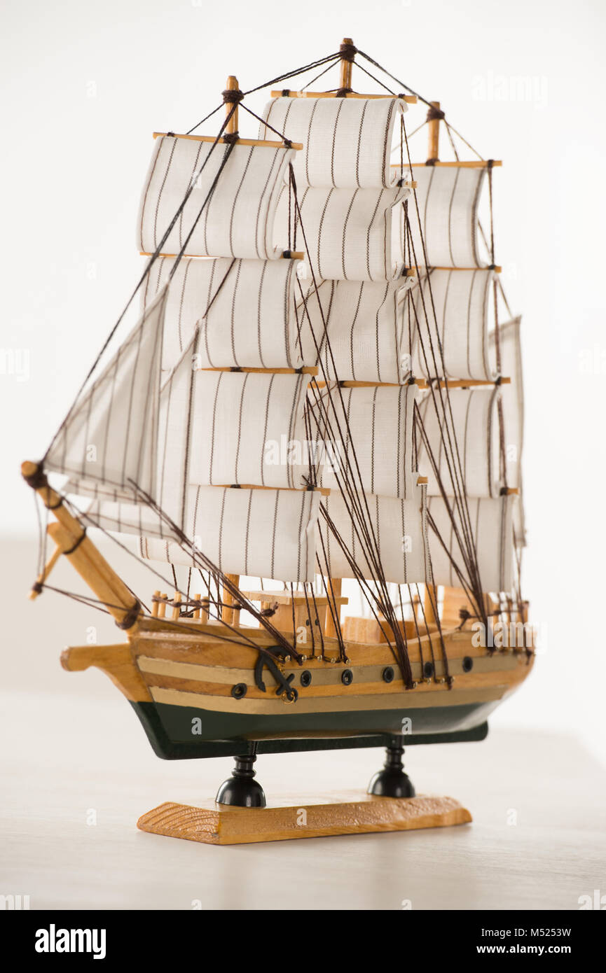 Wooden ship toy model on white table against white background Stock ...