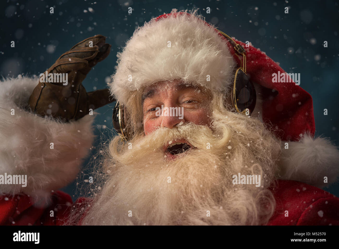 Santa Claus is listening to music in headphones wearing sunglasses ...