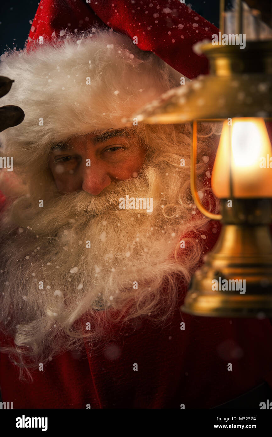 Photo of Santa Claus outdoors under blowing wind and falling snow and ...