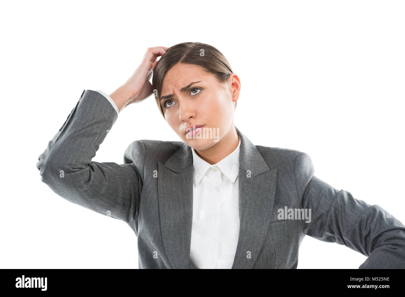Portrait of confused female executive thinking on white background ...