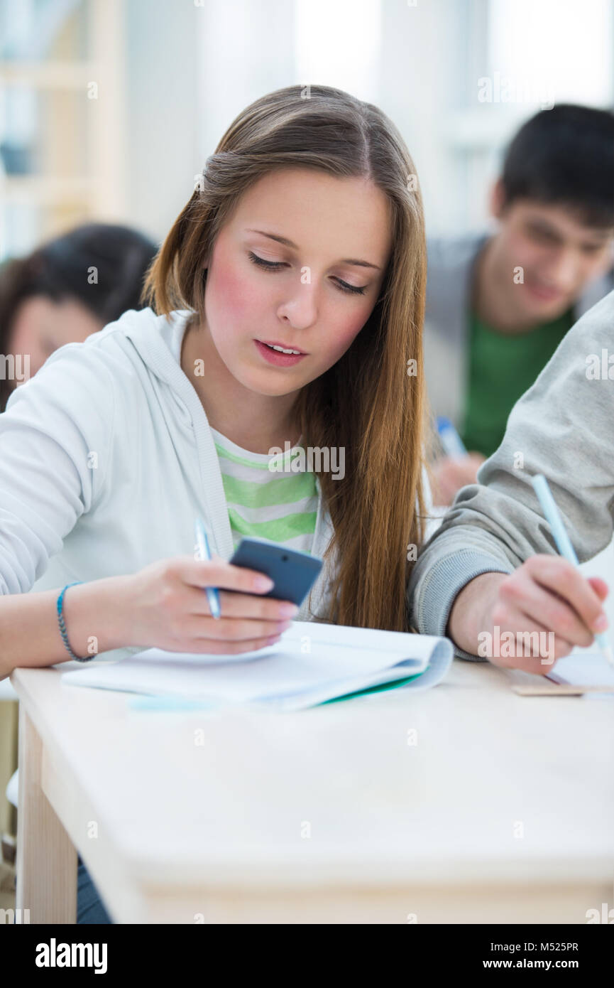 High School students. Beautiful girl calculating numbers in classroom ...