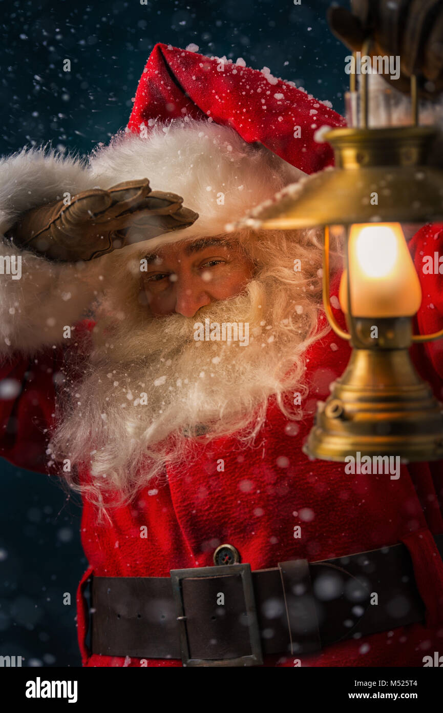 Photo of Santa Claus outdoors under blowing wind and falling snow and ...