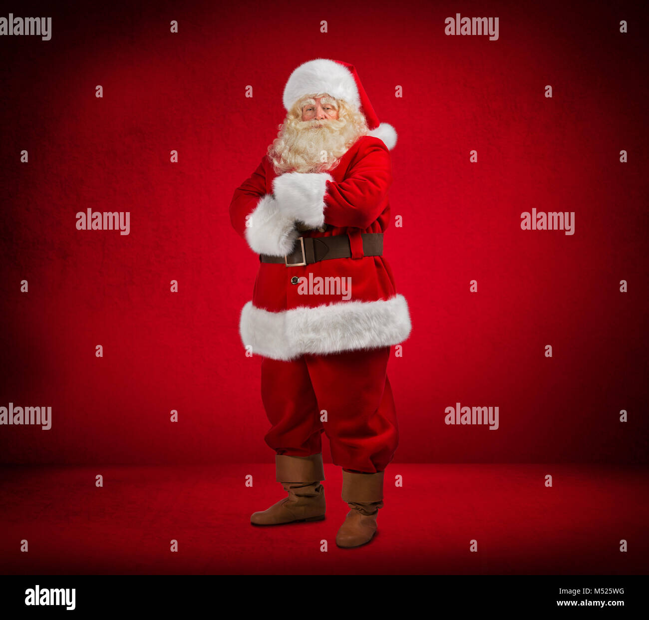 Photo of happy Santa Claus looking at camera on red background. Full ...