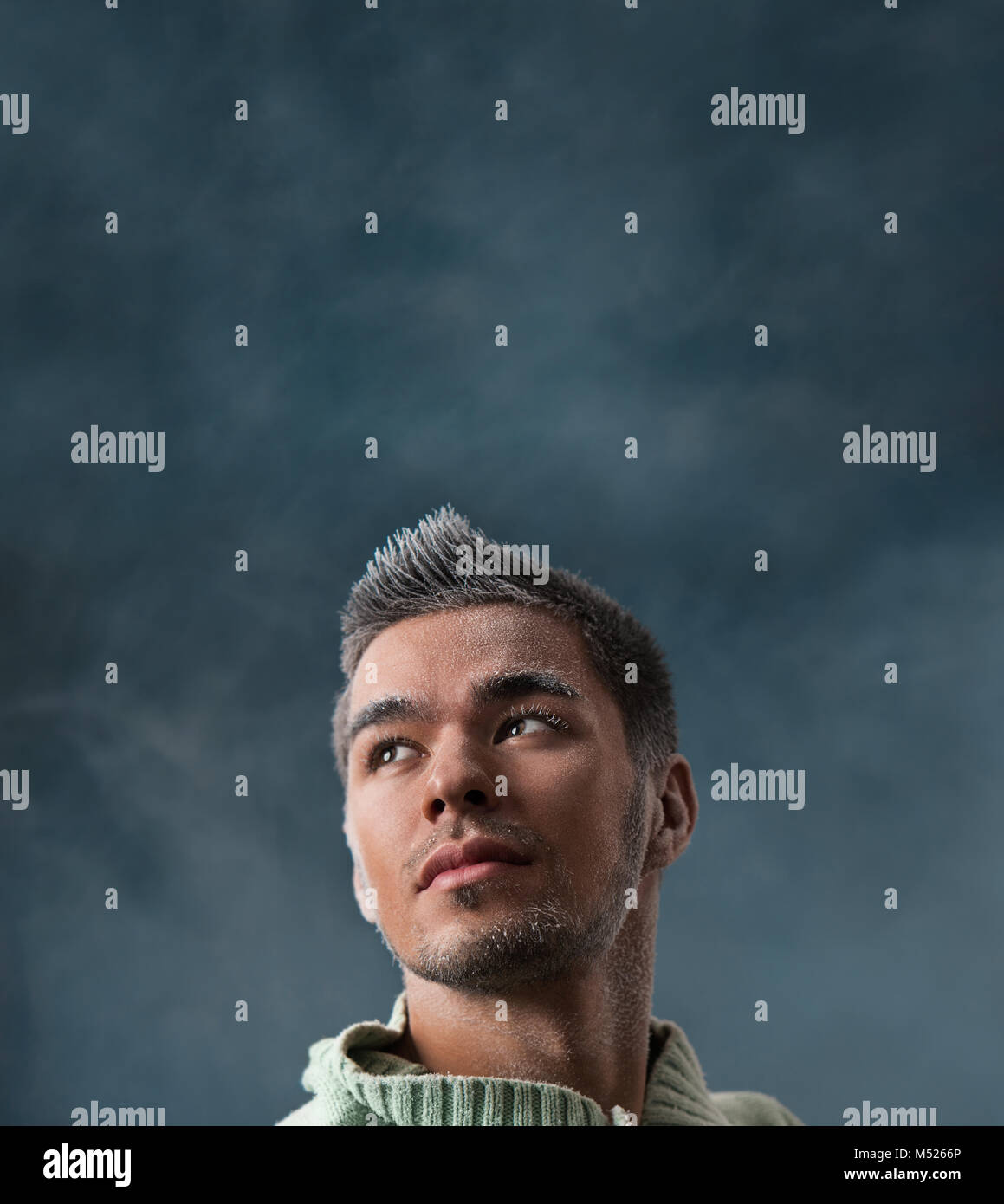 Winter fashion man portrait with frost makeup on dark smoky background ...