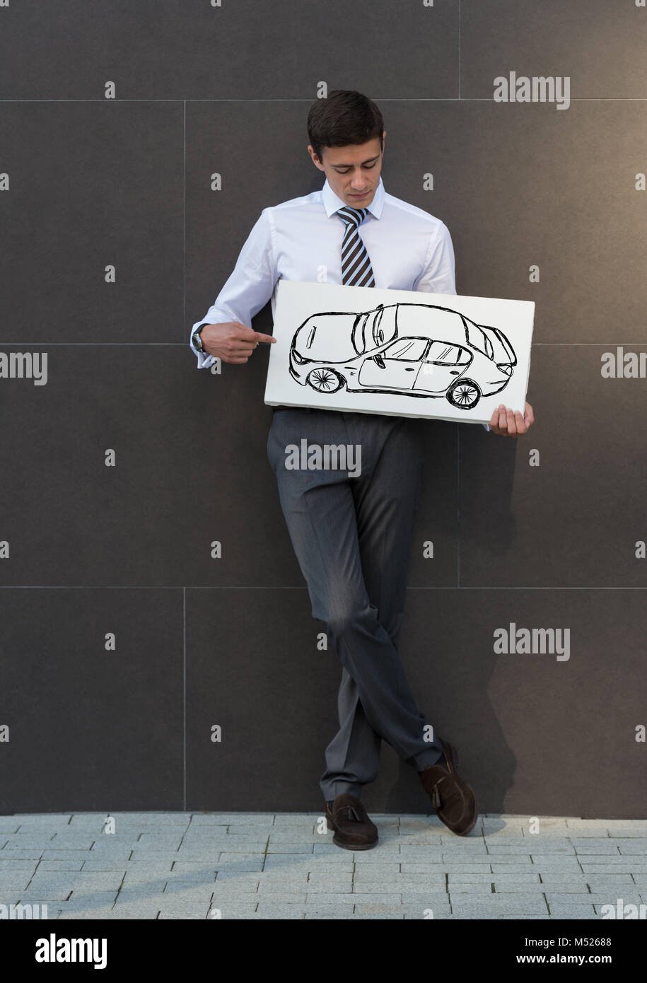 Business man with new car sign. Dealer or buyer showing car sign ...