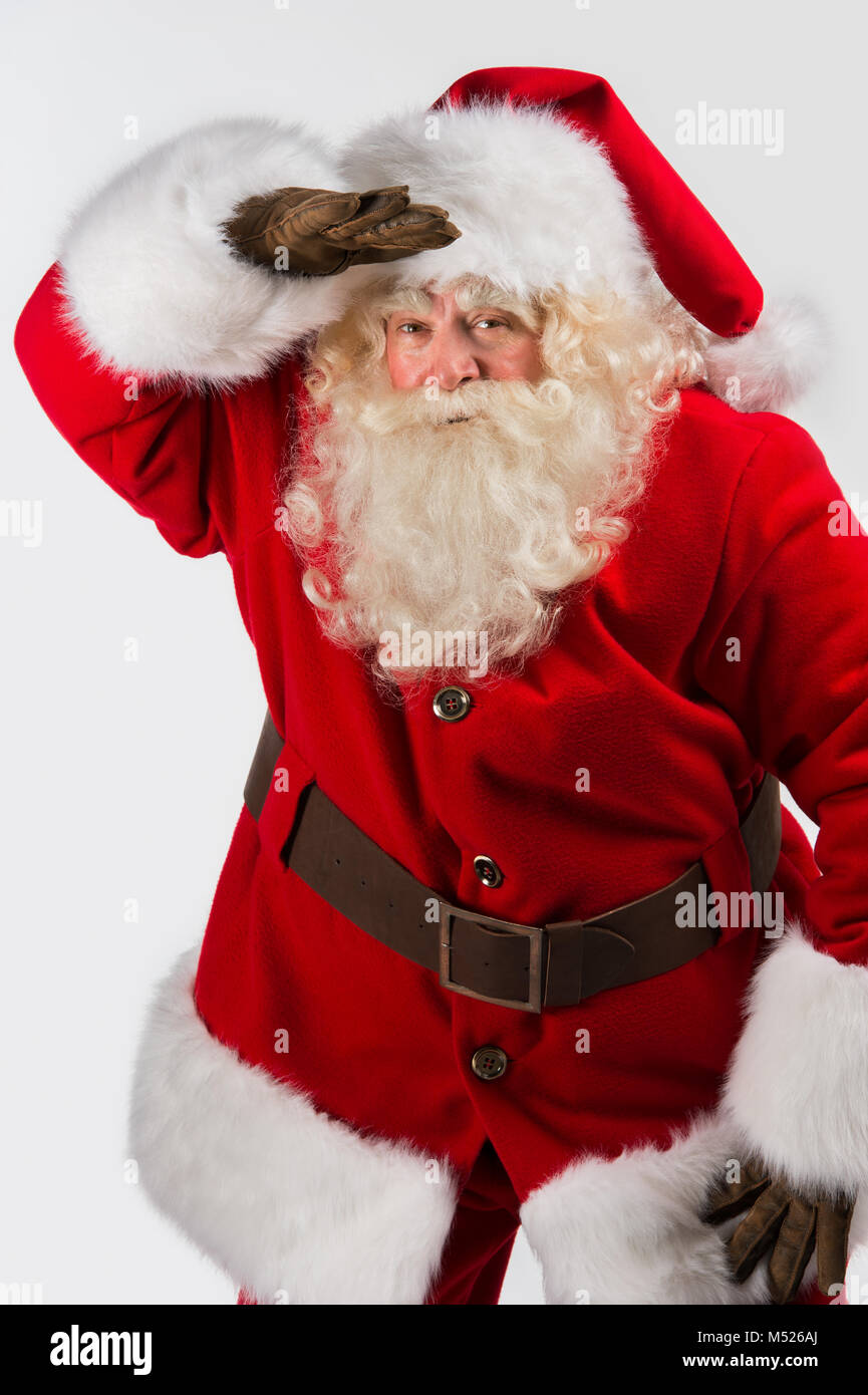 Santa Claus standing isolated on white background and looking far away ...