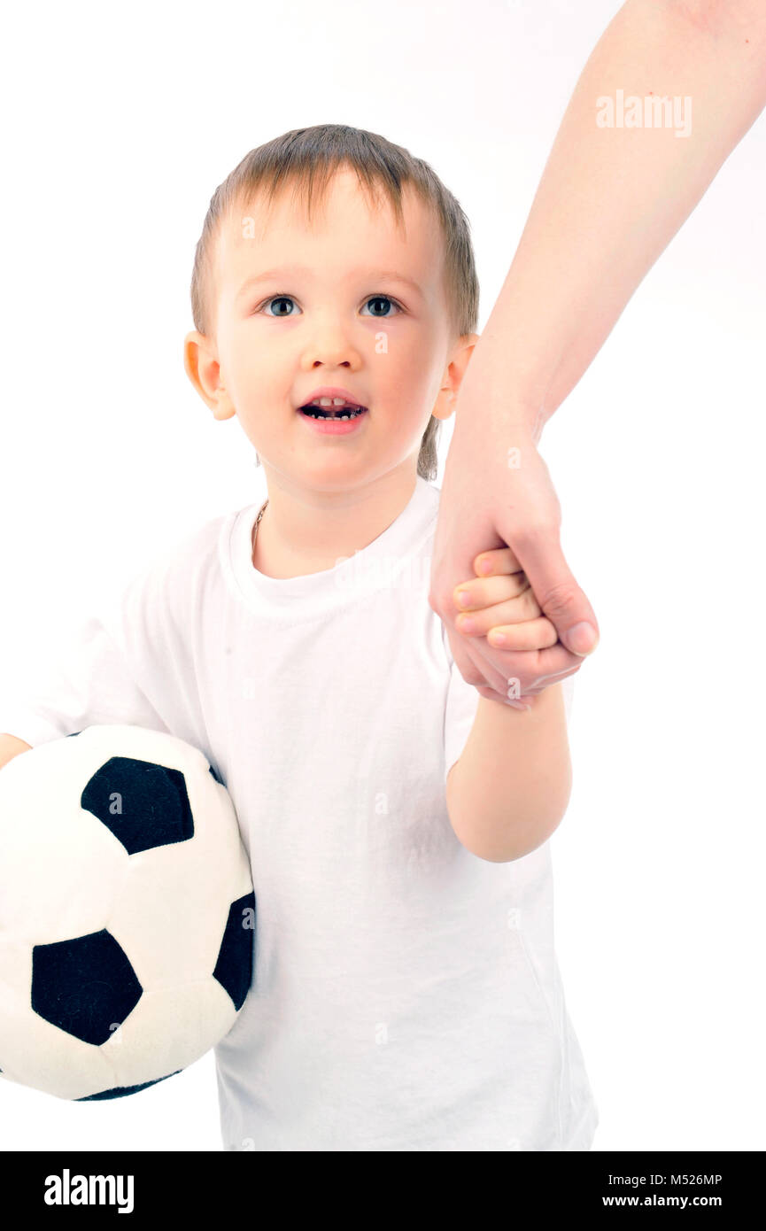 LIttle boy holding a soccer ball hand in hand with parent Stock Photo ...