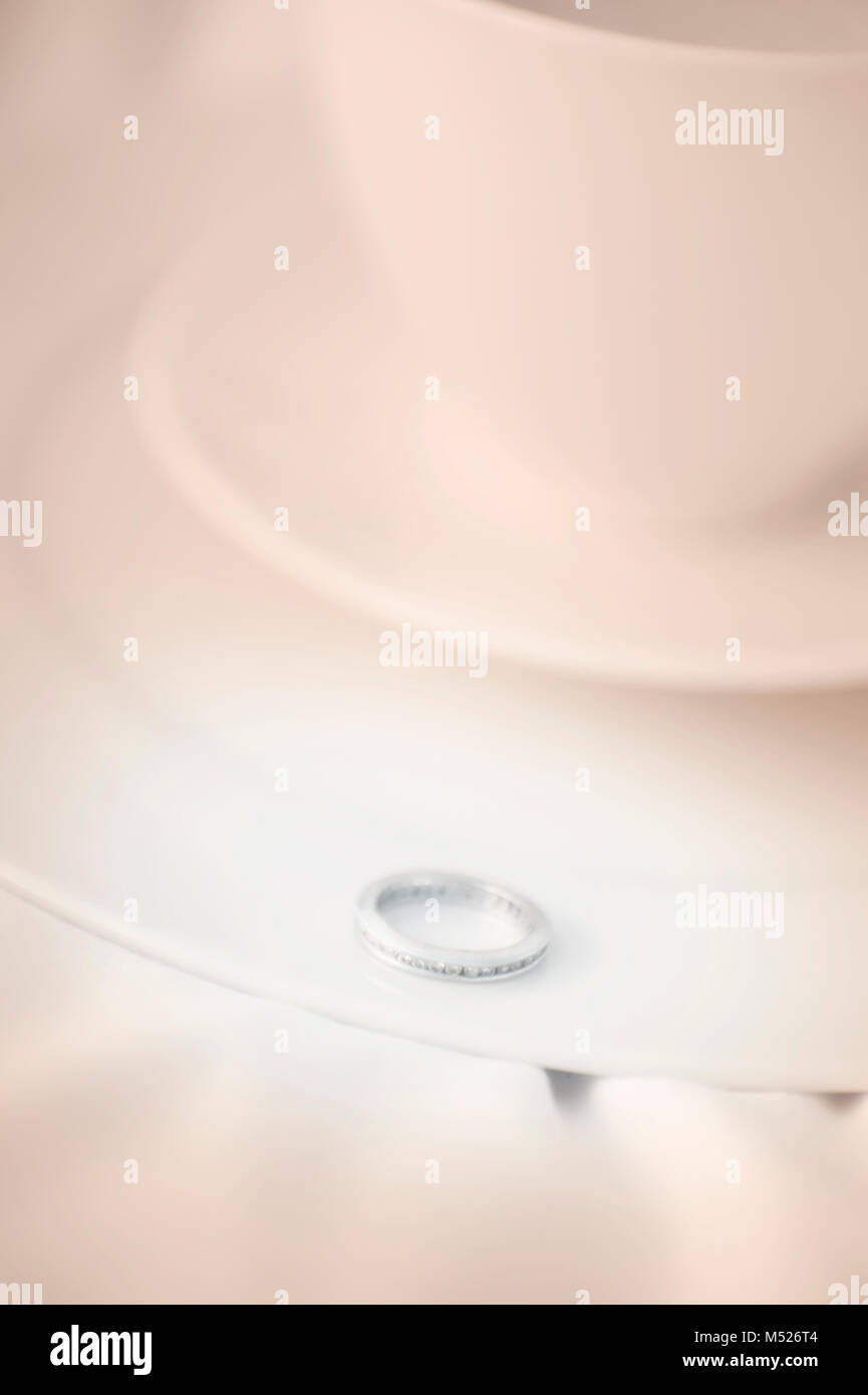 Engagement ring on a coffee saucer. Wedding proposal Stock Photo - Alamy