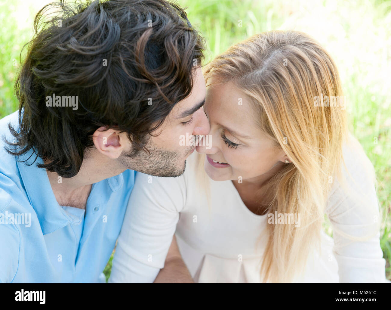 Happy young couple sharing affection Stock Photo - Alamy