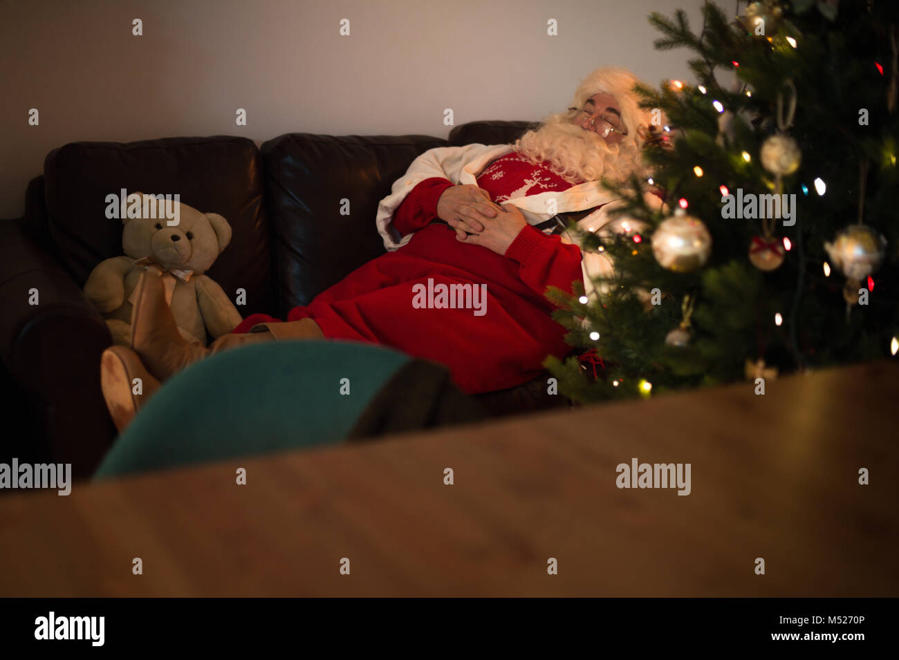 Santa Claus at Home resting on couch Stock Photo - Alamy