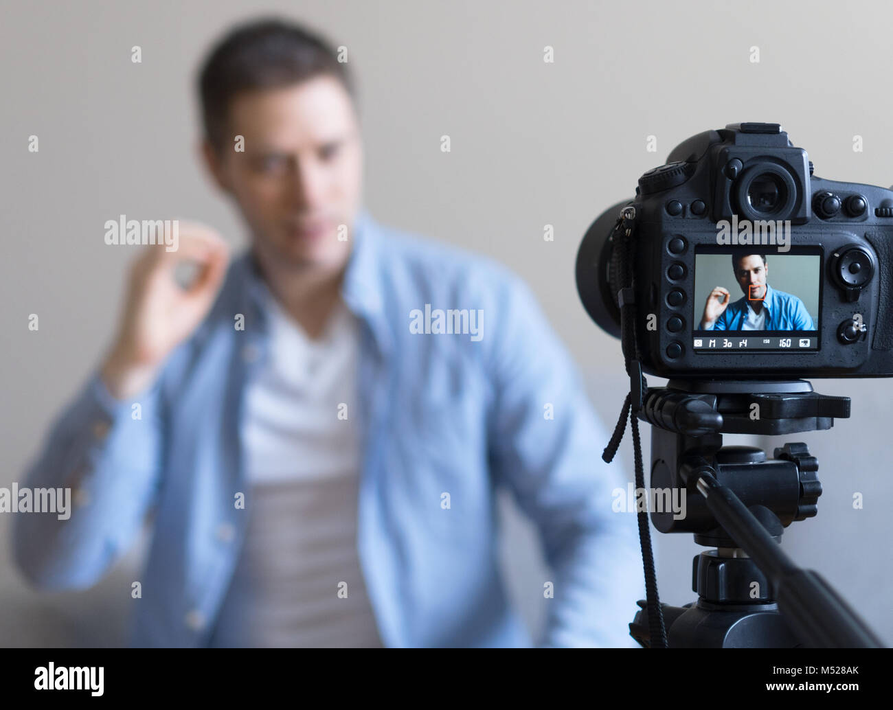 Handsome man making video blog. Focus on camera Stock Photo - Alamy