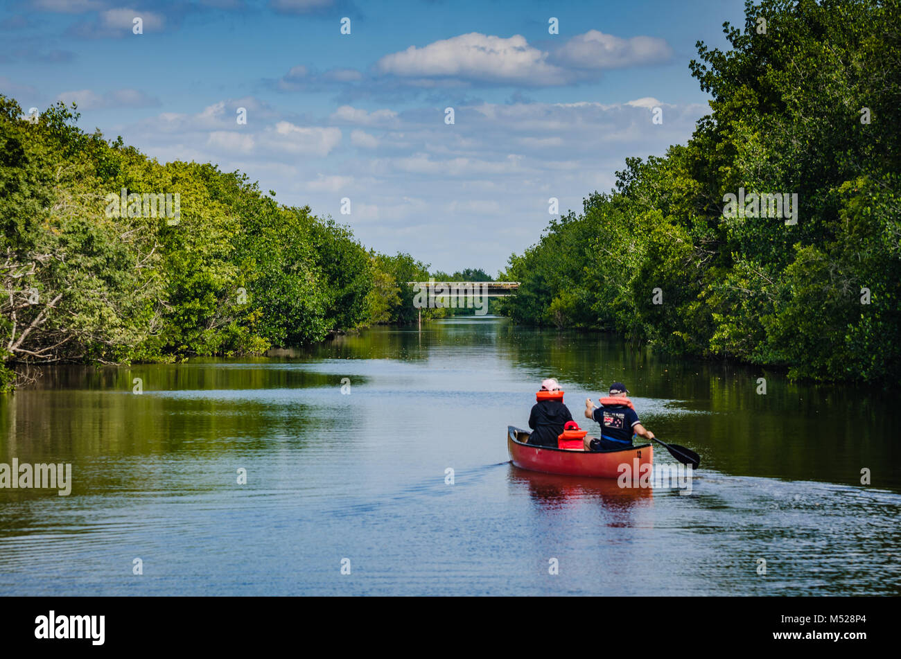 Family rows a red canoe on Biscayne Bay Lagoon at Biscayne National ...