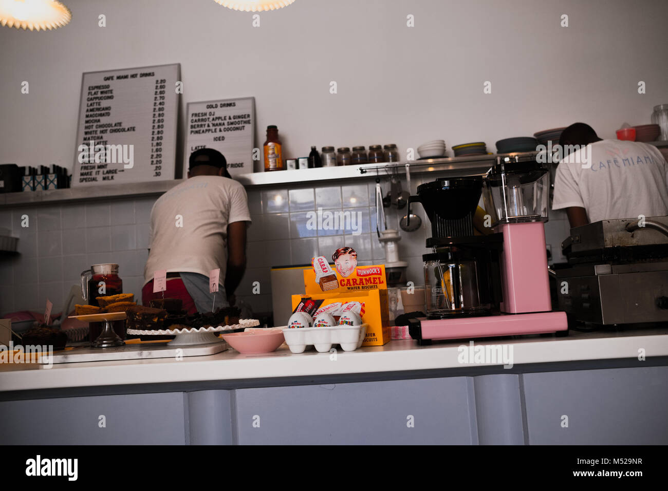 Men working behind the counter at a cafe in London, England Stock Photo ...