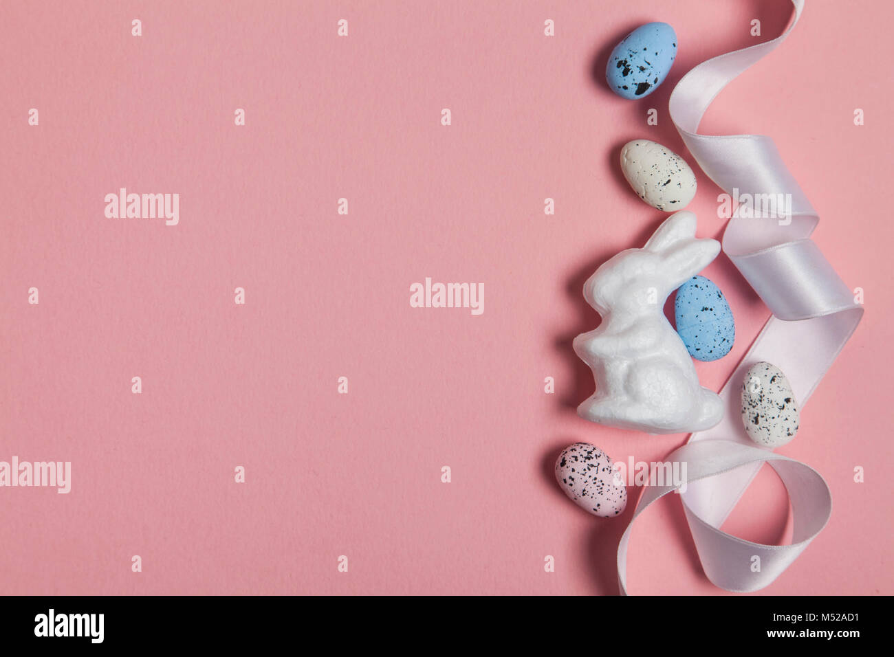 Pastel pink easter holiday background with eggs and easter bunnies ...