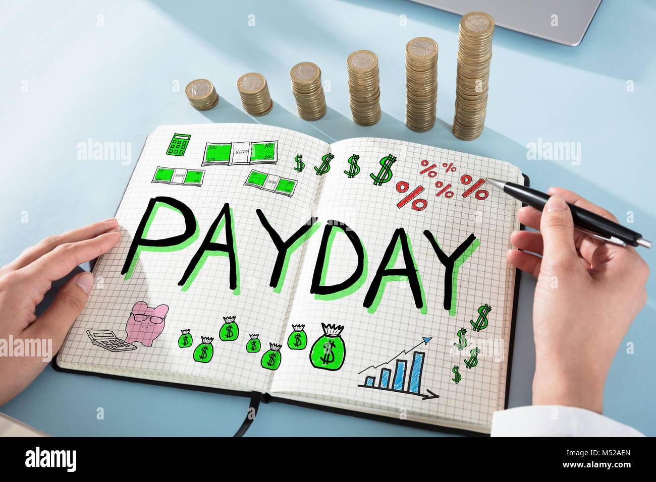 Woman Drawing Payday Employee Compensation In Notepad Stock Photo - Alamy