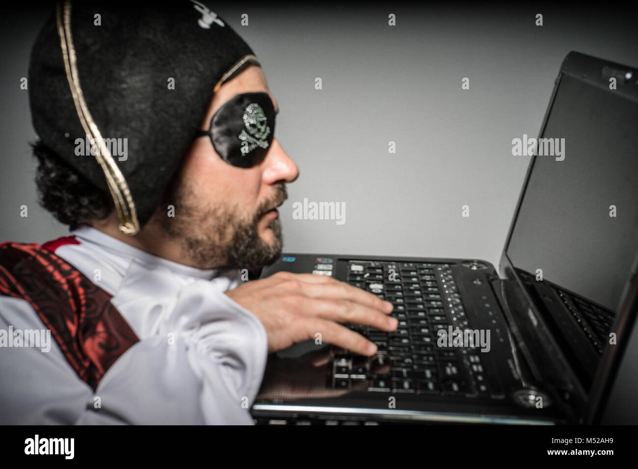 Crime, hacker, cyber criminal with pirate clothes, attempt to hack a ...