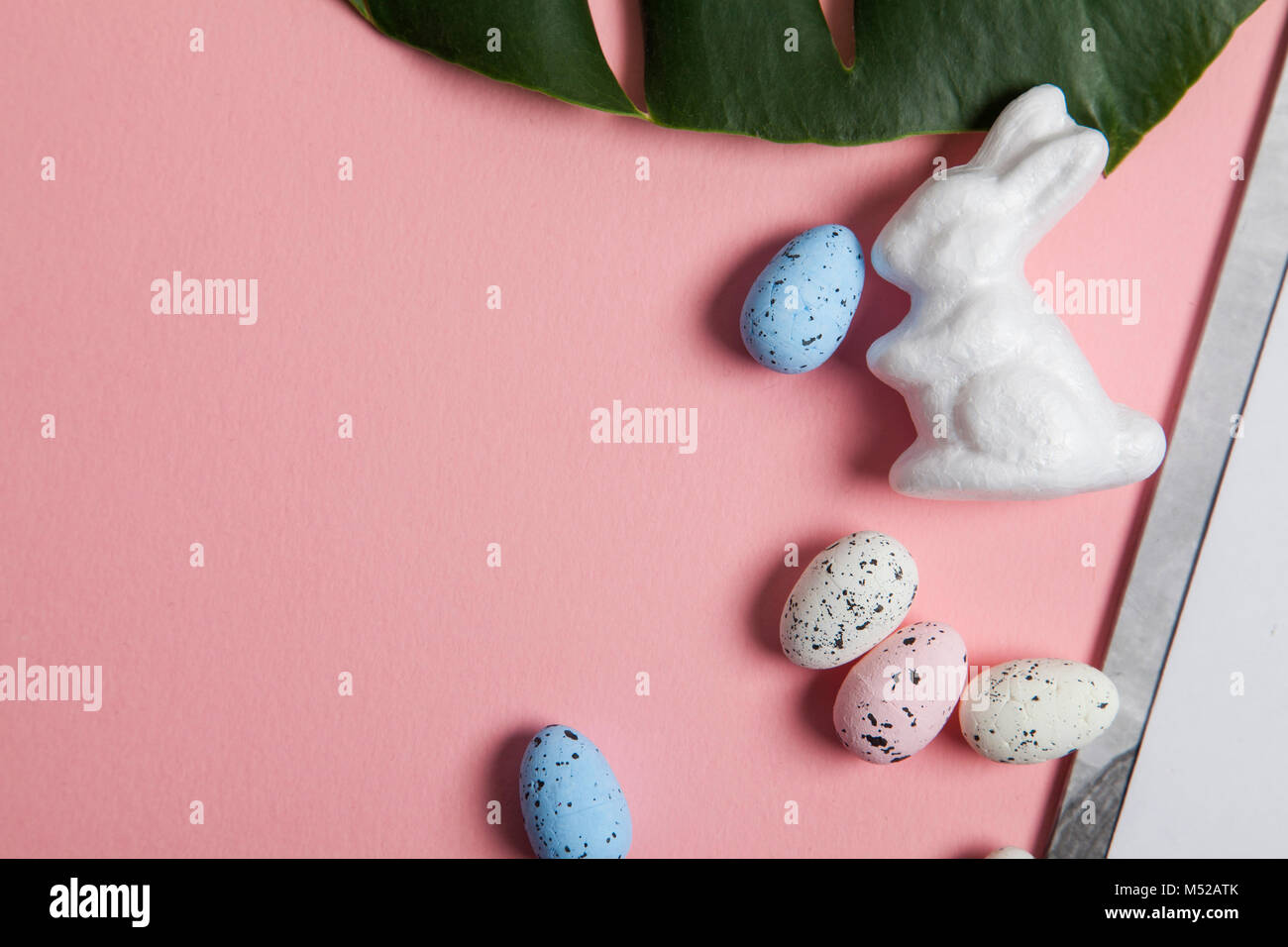 Pastel pink easter holiday background with eggs and easter bunnies ...
