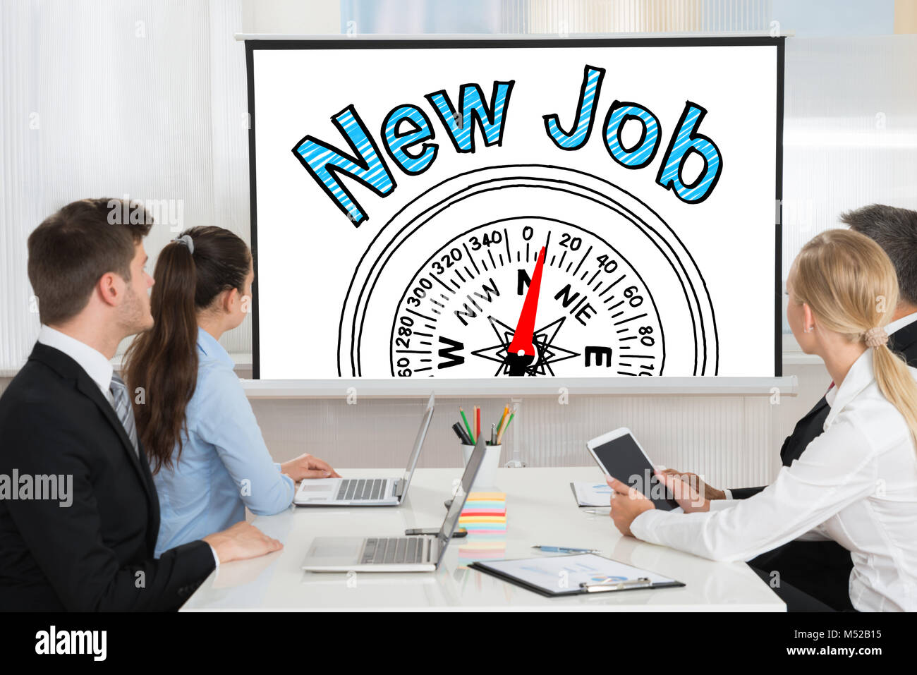 Group Of Workers Looking At New Job Employment Concept Stock Photo - Alamy
