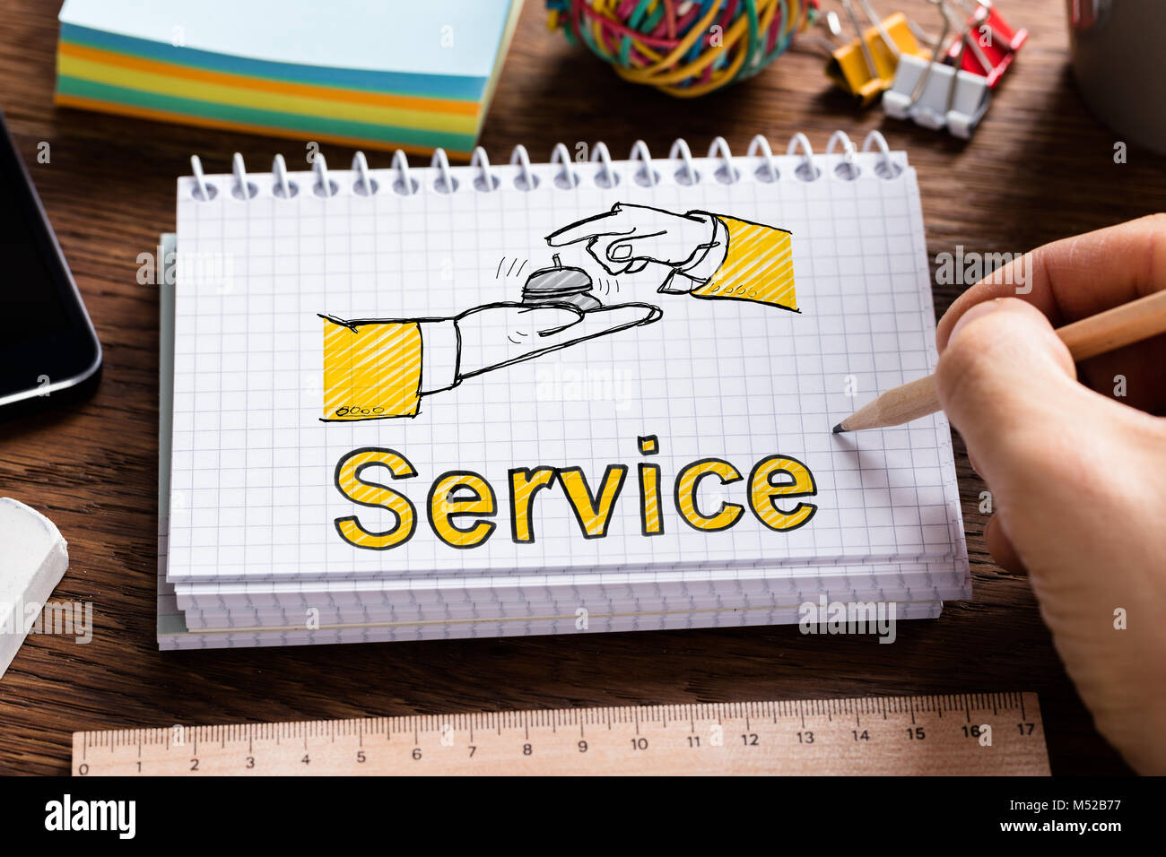 Man Drawing Hospitality Service Concept In Notepad Stock Photo - Alamy